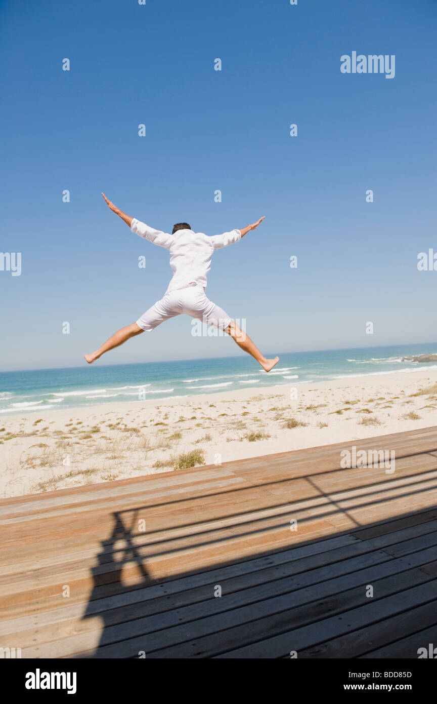 Man jumping on the beach Stock Photo - Alamy