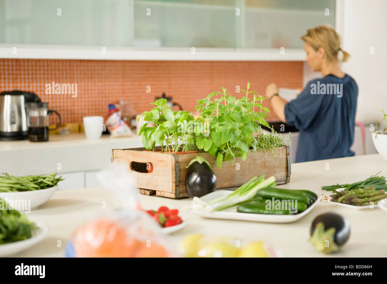 Woman working in the kitchen Stock Photo - Alamy