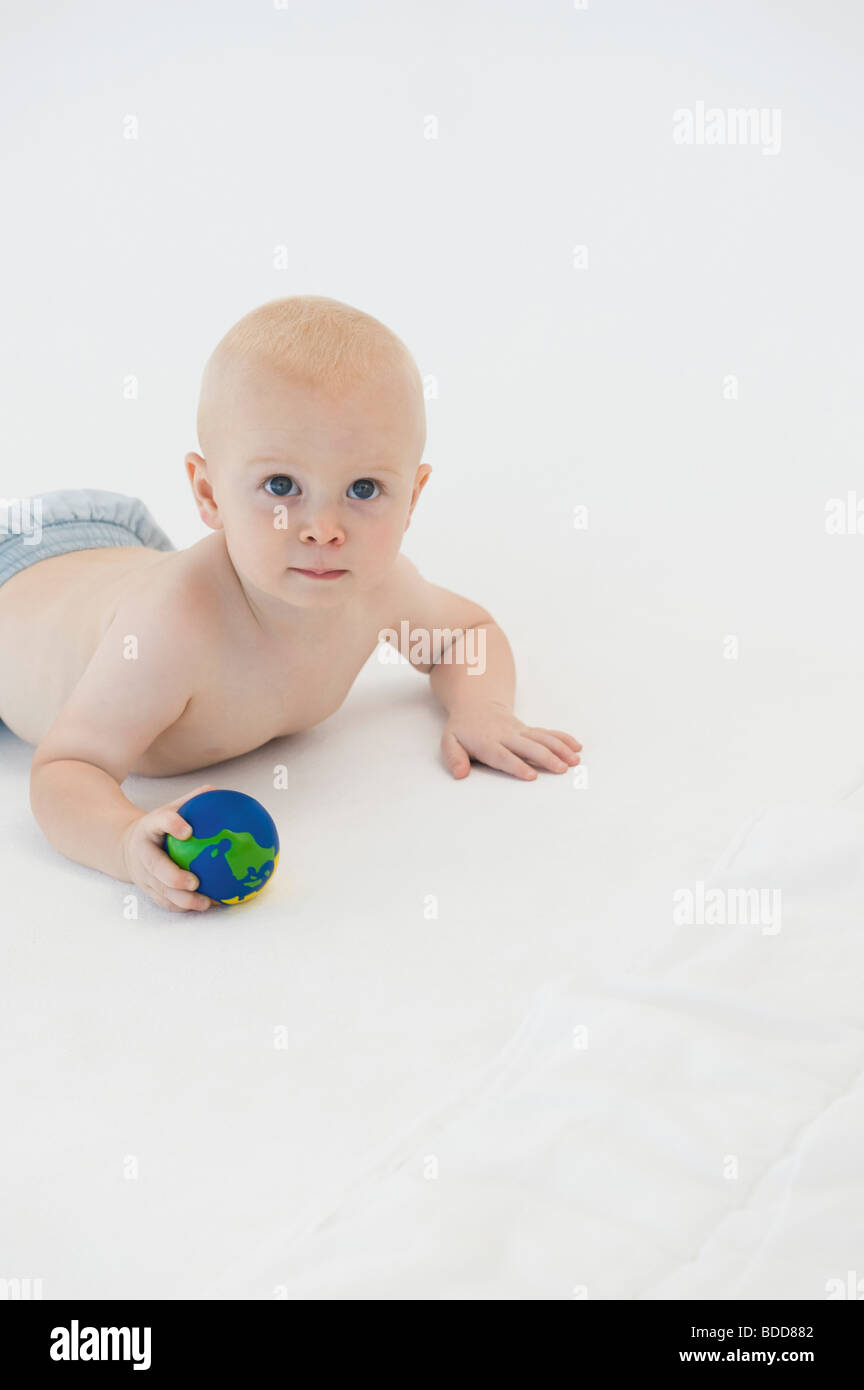 Baby boy holding a ball Stock Photo - Alamy