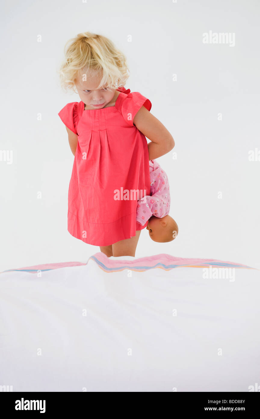 Girl holding a doll hi-res stock photography and images - Alamy