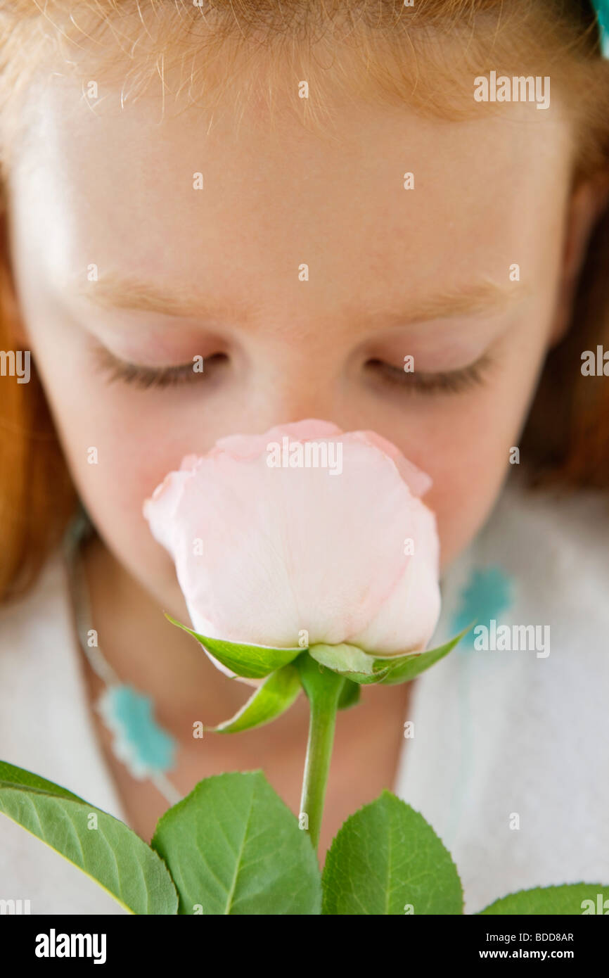 Close-up of a flower girl smelling a flower Stock Photo - Alamy
