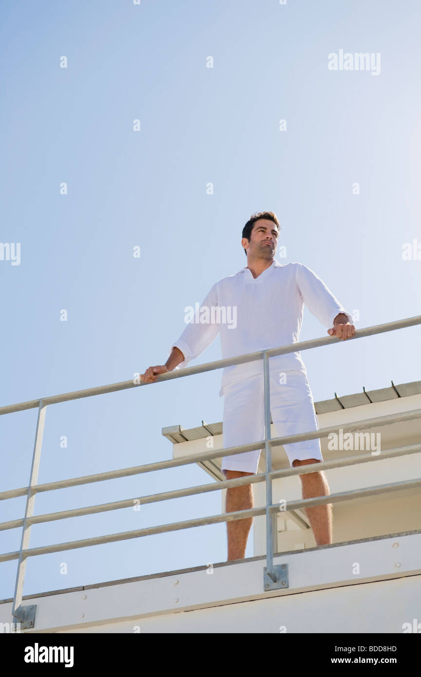 Man standing on the beach house Stock Photo - Alamy