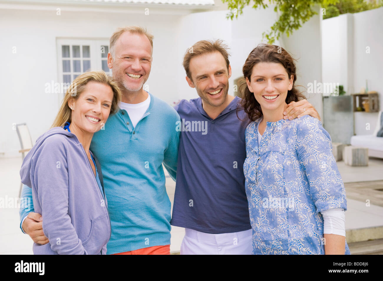 Portrait of two couples smiling together Stock Photo - Alamy