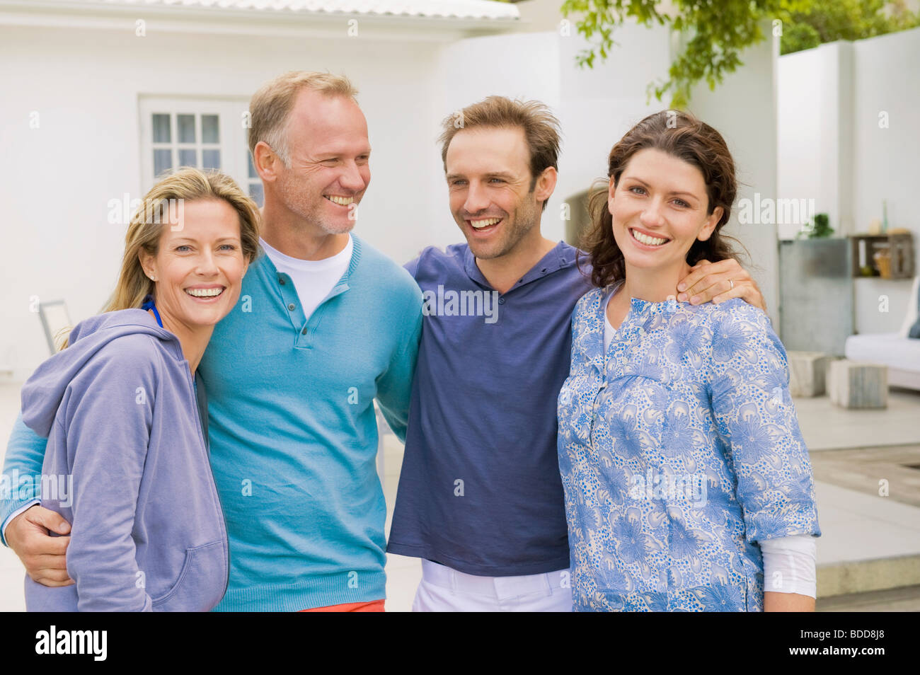 Two couples smiling Stock Photo - Alamy