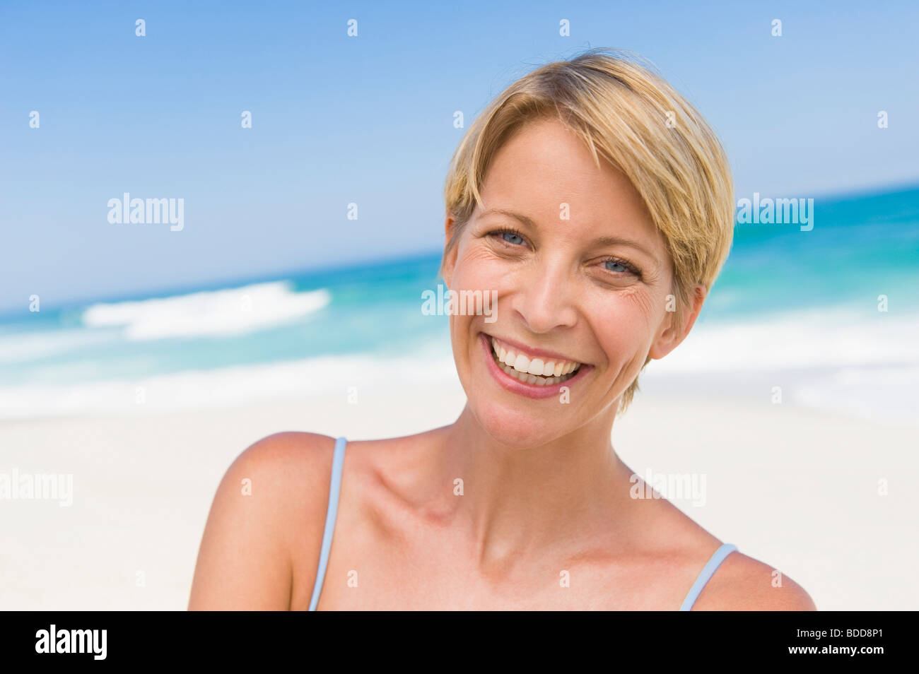 Portrait of a woman smiling on the beach Stock Photo - Alamy