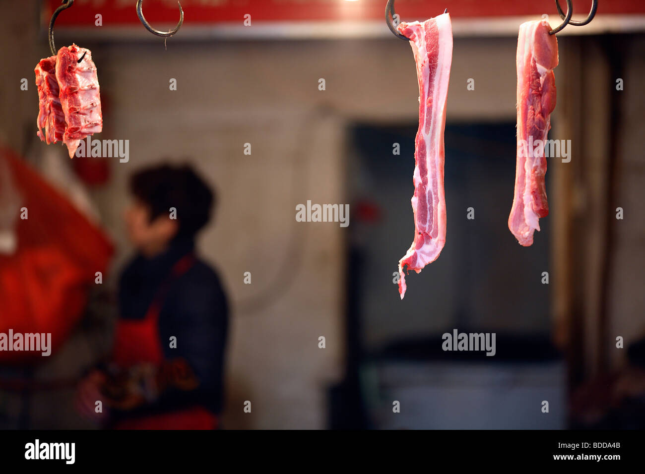 Hanging meat at a butchers market in Shanghai Stock Photo - Alamy
