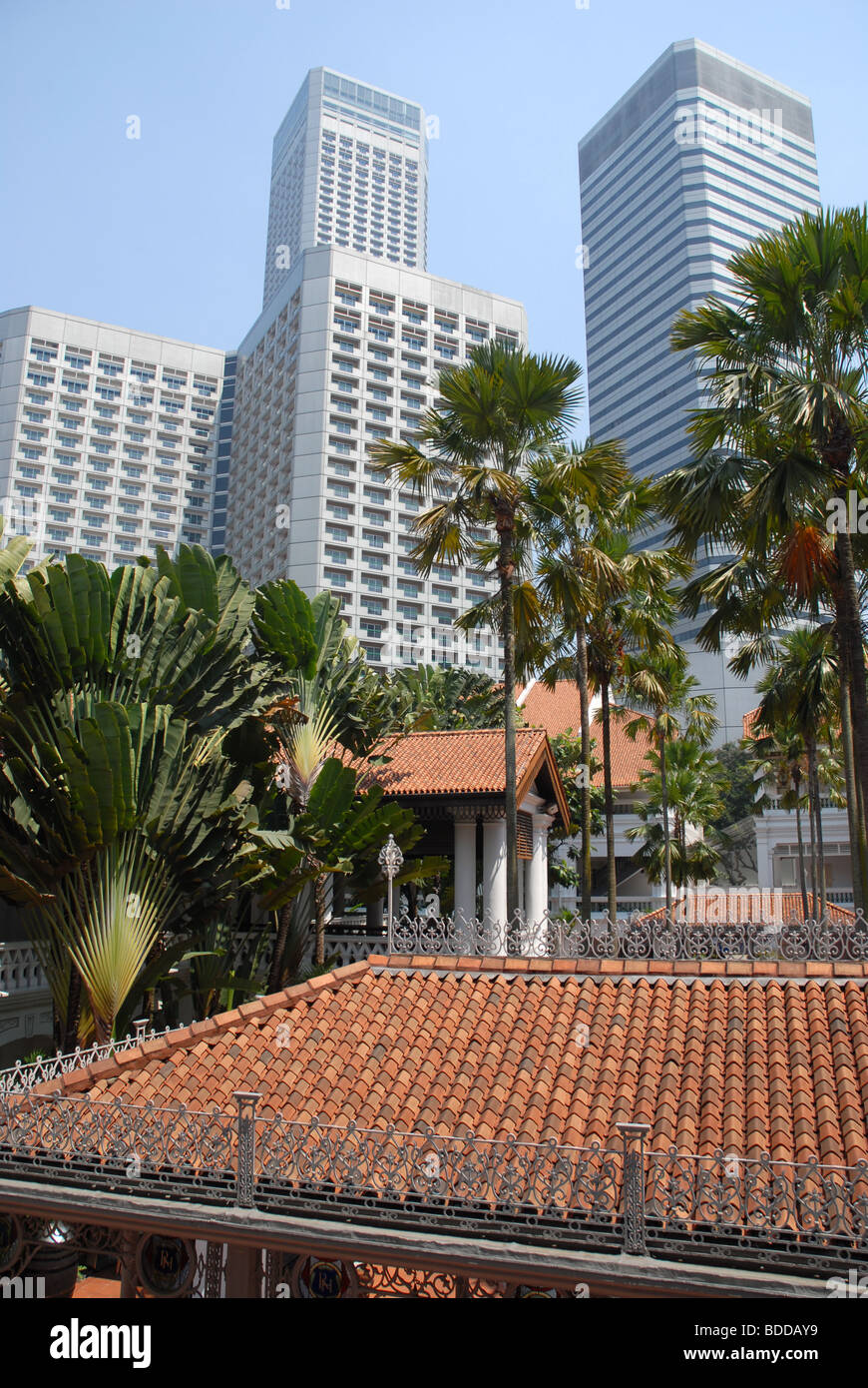 view over red tiled roof in Raffles Courtyard to modern city ...