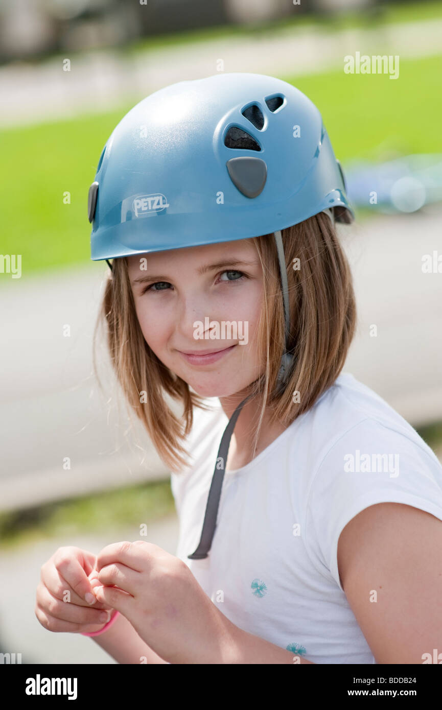 Young girl wearing a hard hat safety helmet, about to go climbing, UK ...