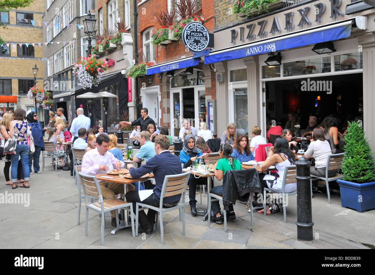 Pizza Express restaurant with people eating out dining outdoors in St ...