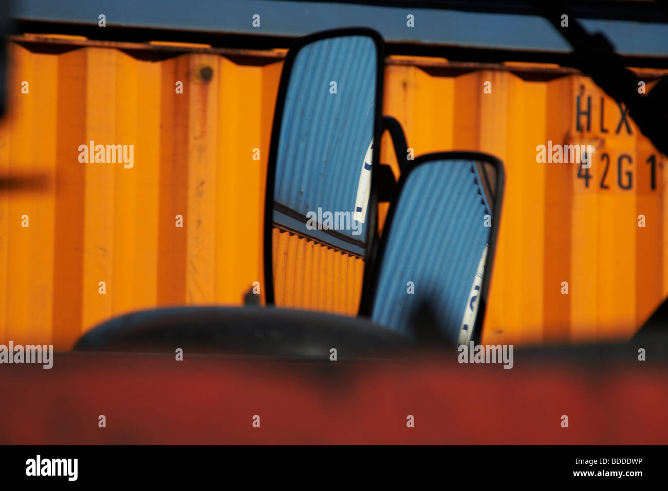 rearview mirrors in front of a orange container Stock Photo - Alamy