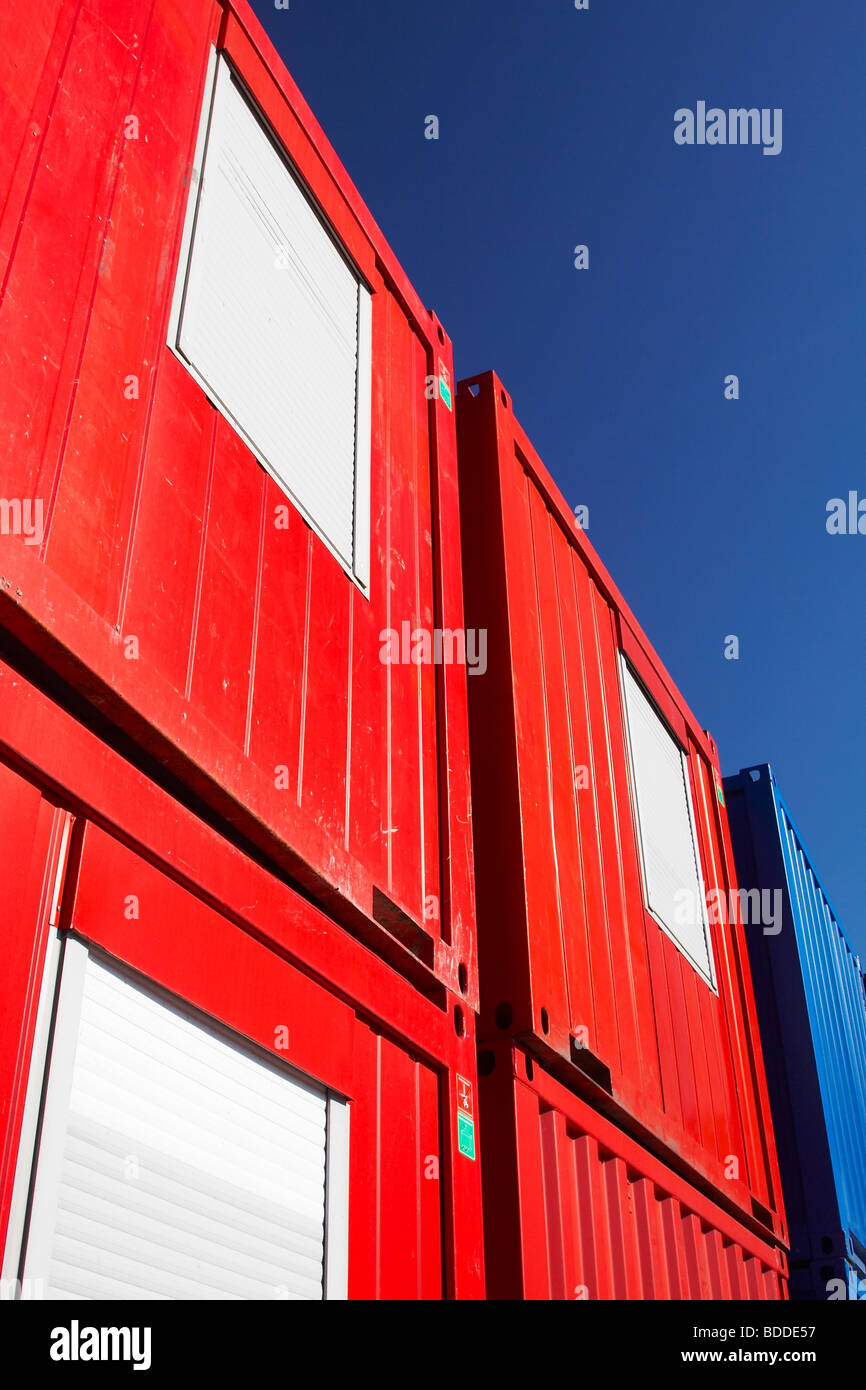 stacked red containers with white windows Stock Photo - Alamy