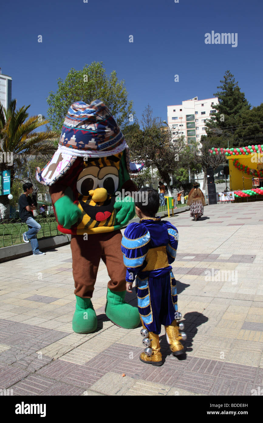 A young boy with a person dressed as a fingerprint, the mascot / symbol ...