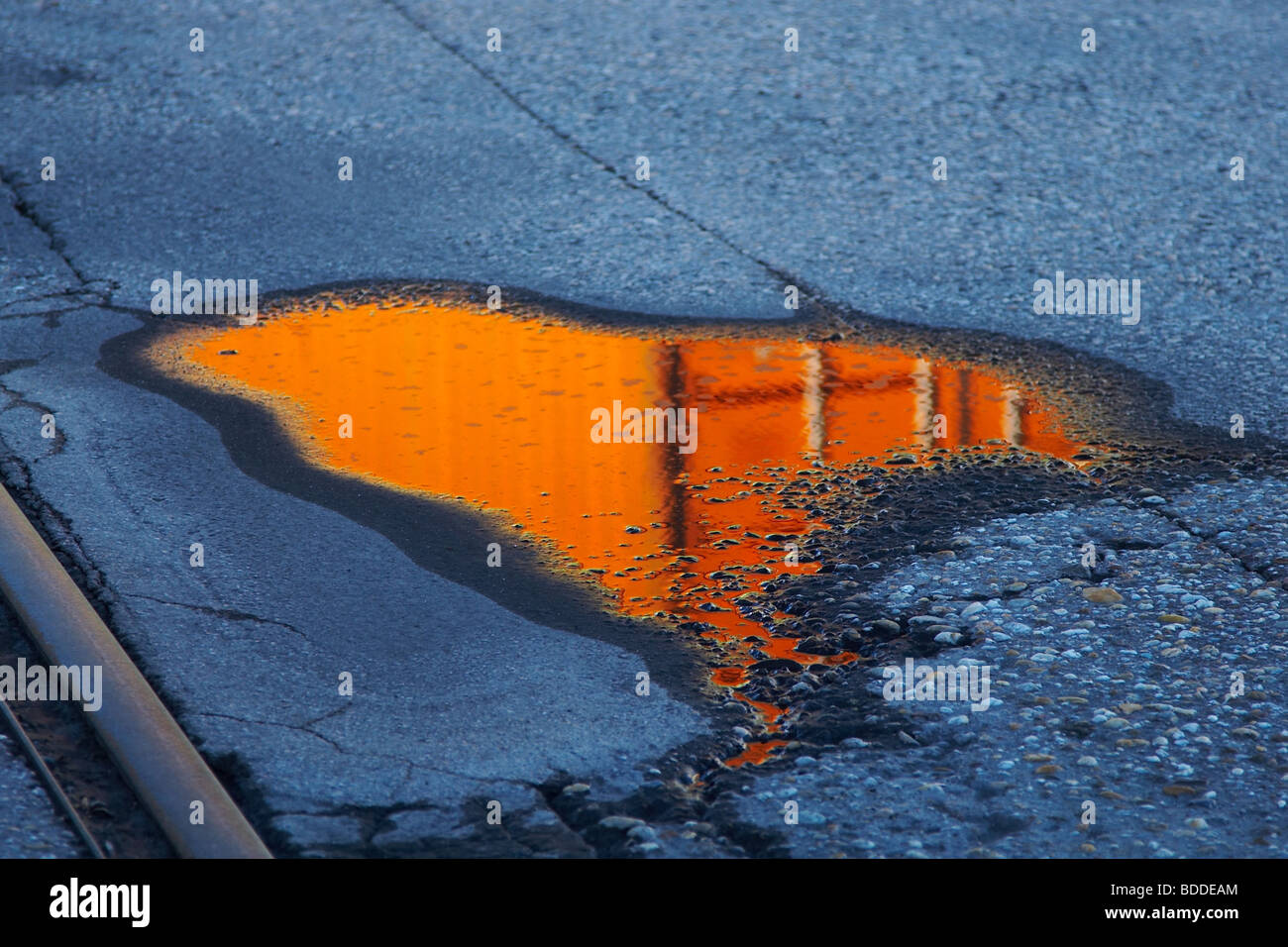 reflection of a orange container in a puddle Stock Photo - Alamy