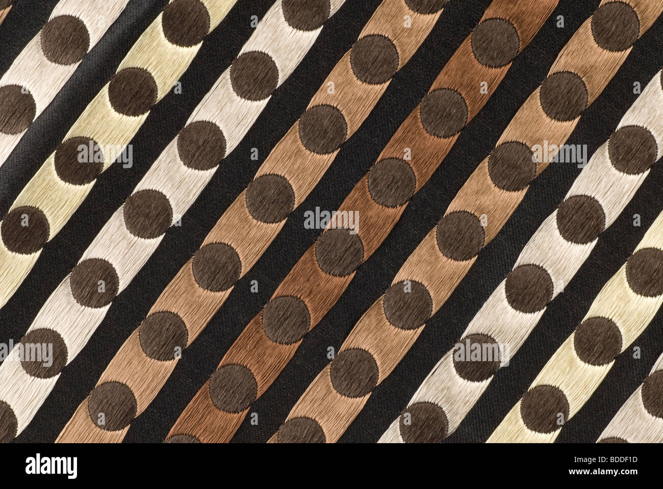 woven textile forming parallel diagonal stripes and rows of circles ...