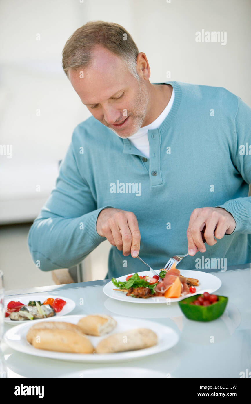 Man having breakfast at a dining table Stock Photo - Alamy