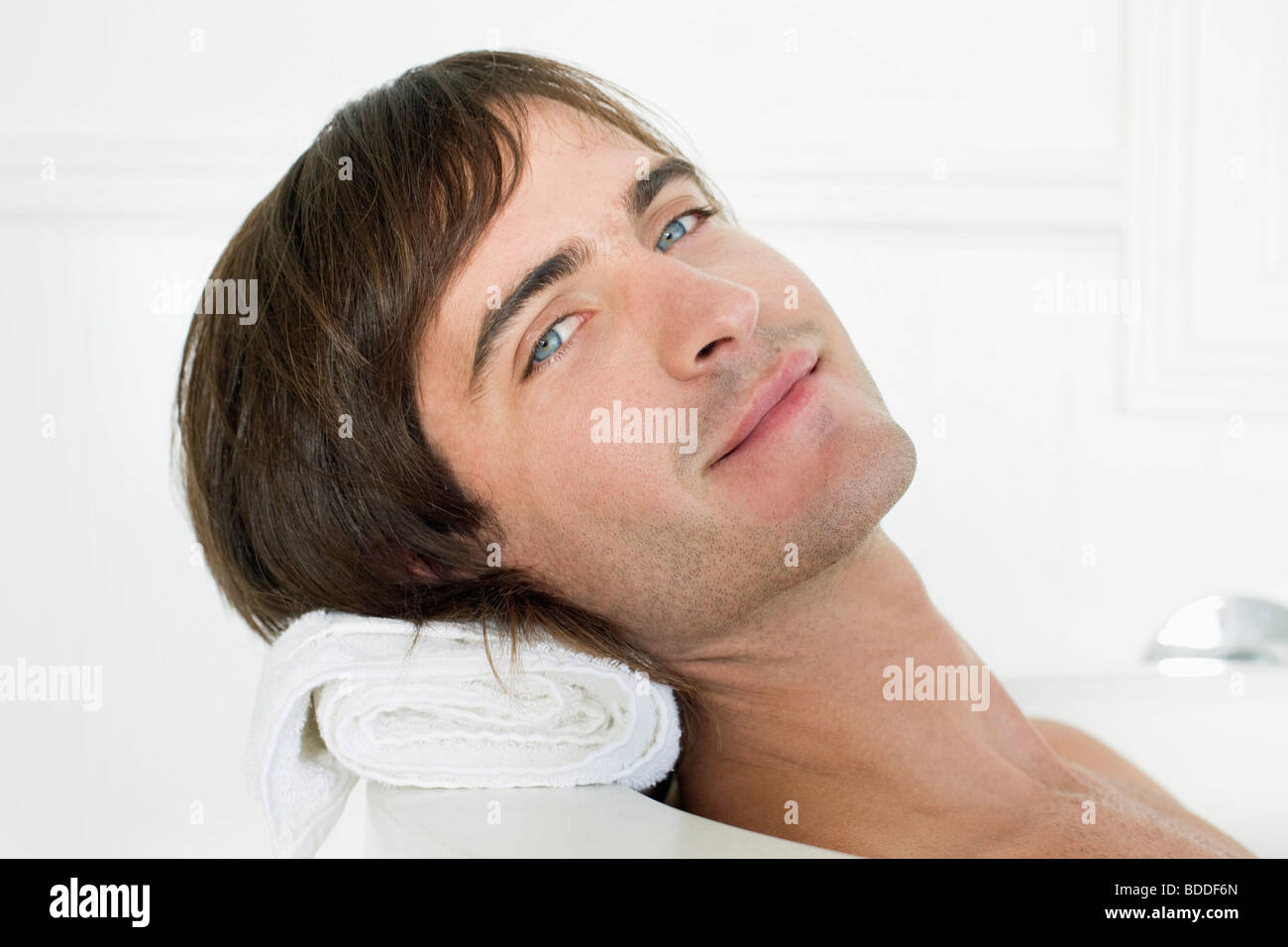 Young man lying in bathtub hi-res stock photography and images - Alamy