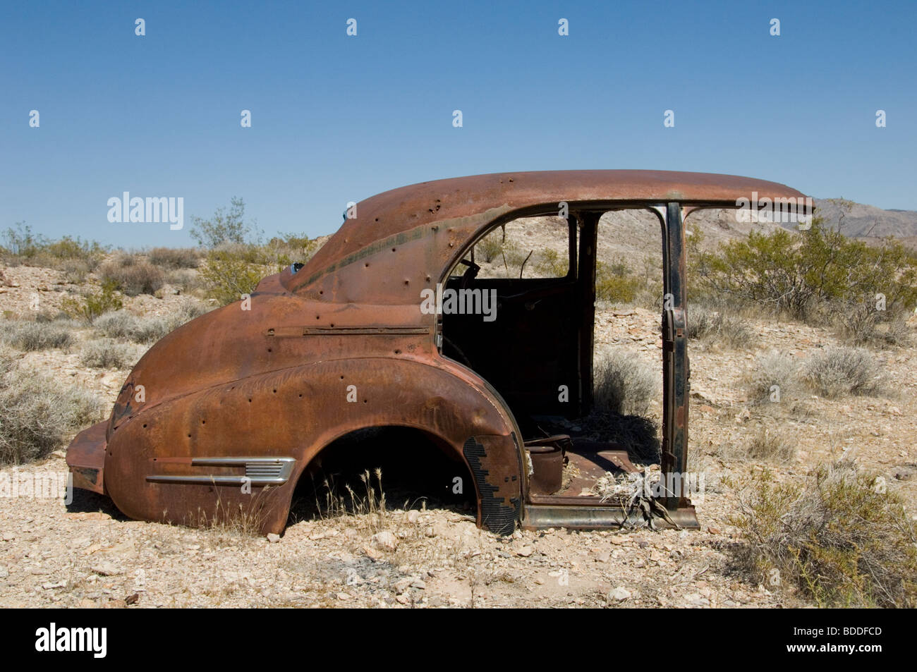 Rusty Burnt Out Shell of Half a Car In Desert Stock Photo - Alamy