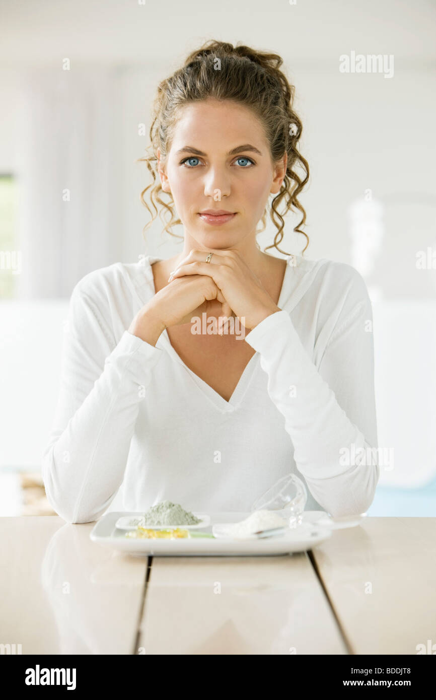 Portrait of a woman sitting at a table with clays on a plate Stock ...