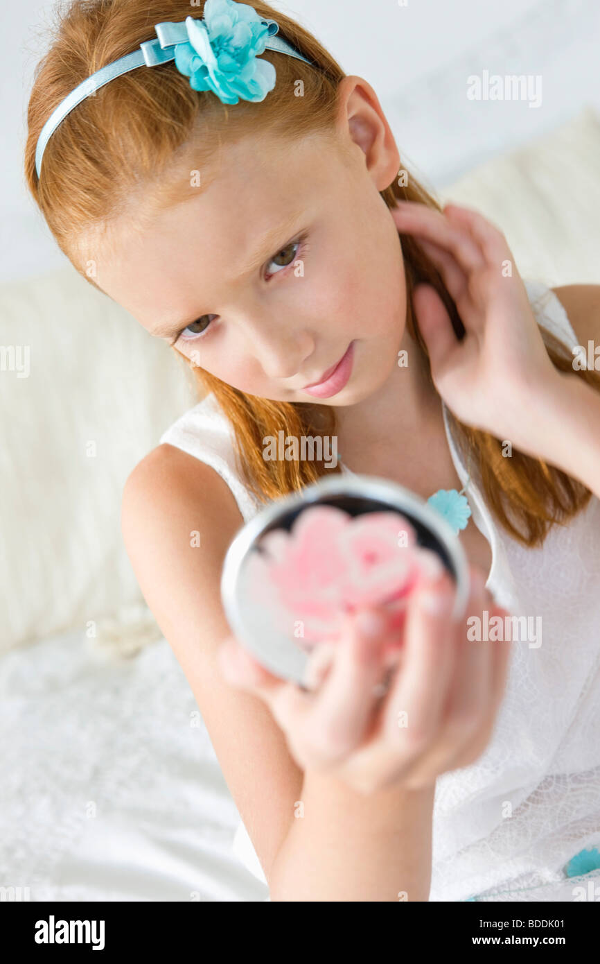 Girl holding a hand mirror Stock Photo - Alamy