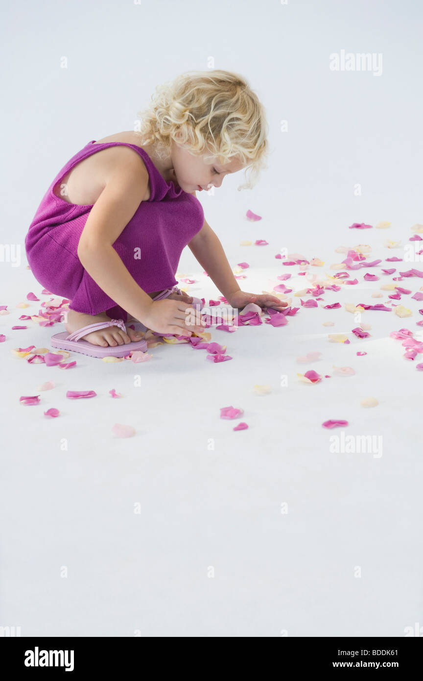 Girl picking up flower petals Stock Photo - Alamy