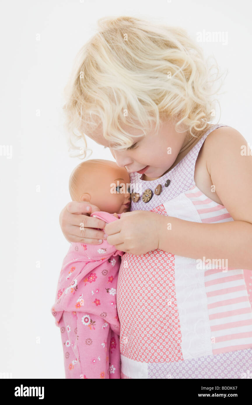 Girl hugging a doll Stock Photo - Alamy