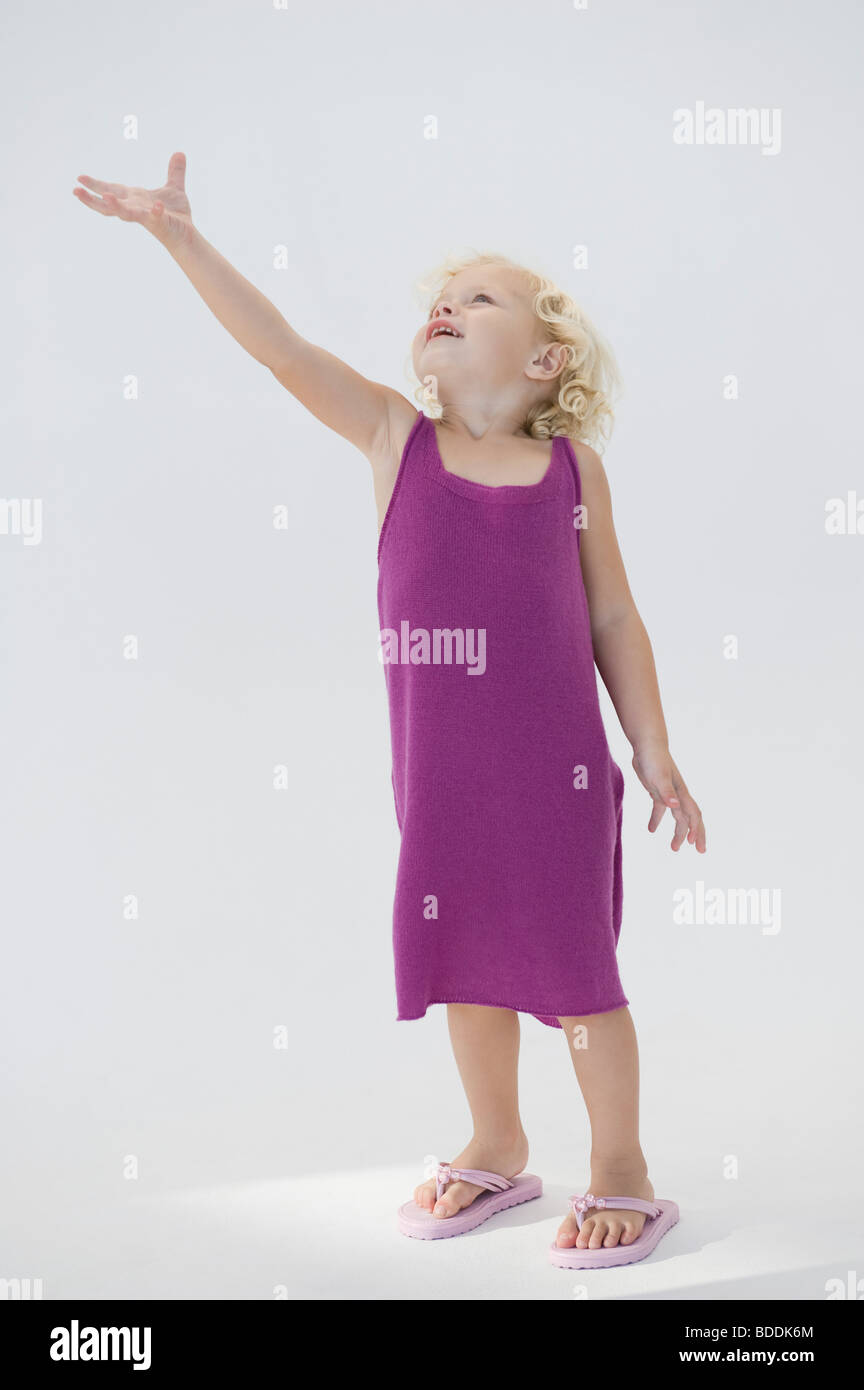 Girl standing with her hand raised Stock Photo - Alamy