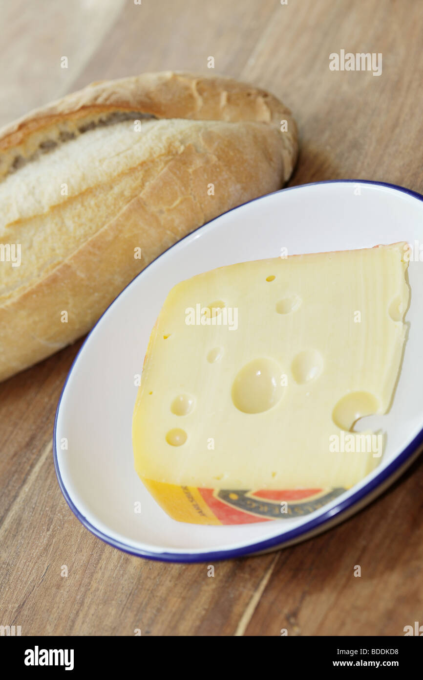 Lump of Swiss Cheese with a Bread Roll Stock Photo - Alamy