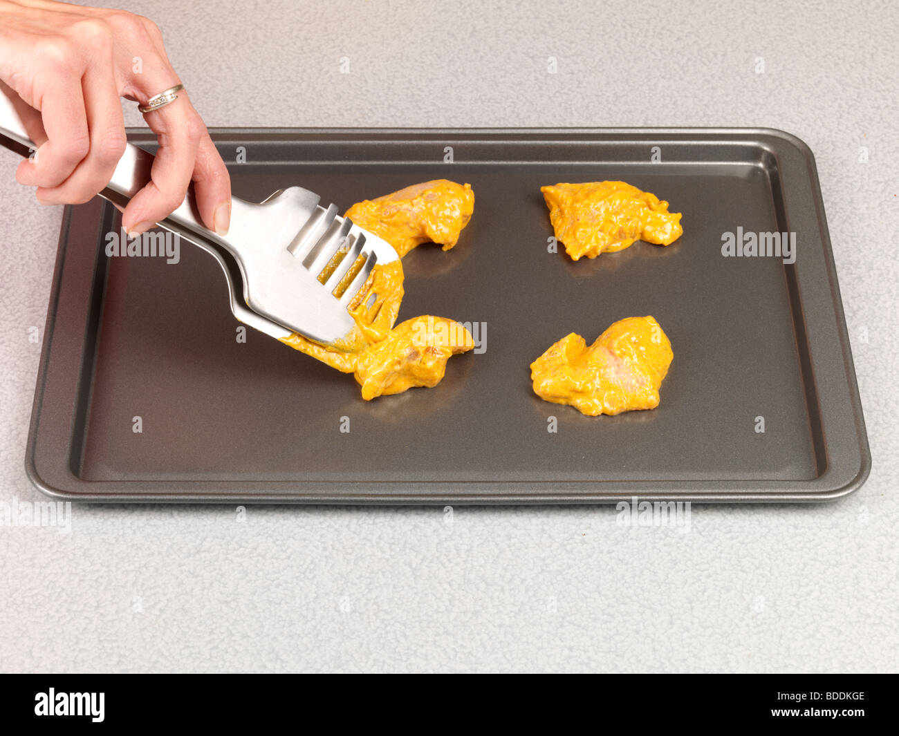 Shot 4 (Placing Chicken onto Baking Tray Stock Photo - Alamy