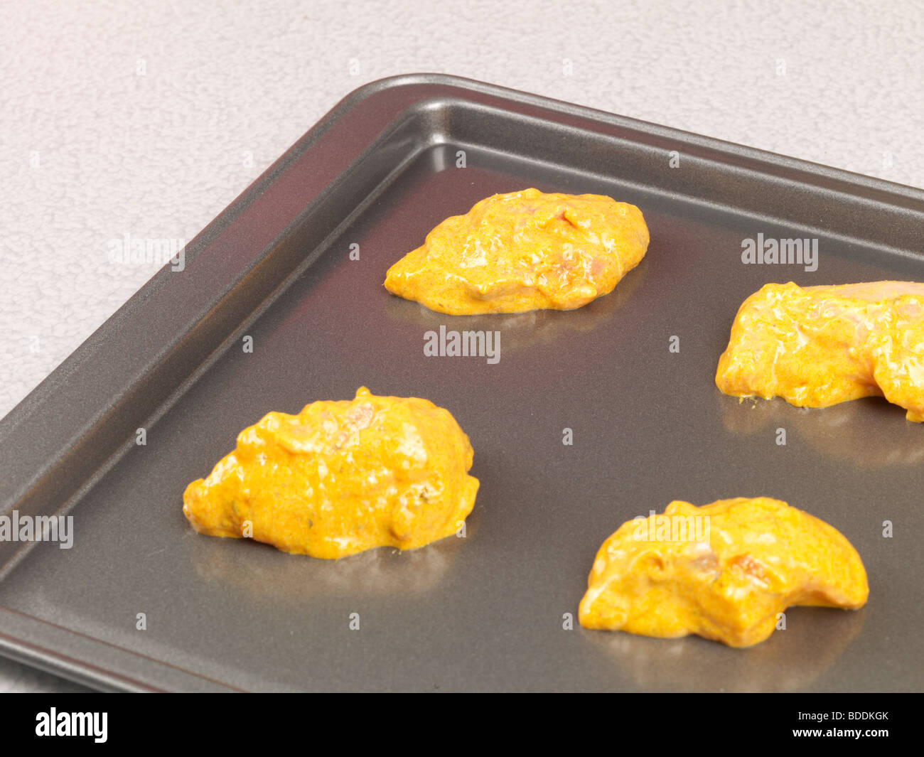Shot 4 (Placing Chicken onto Baking Tray Stock Photo - Alamy
