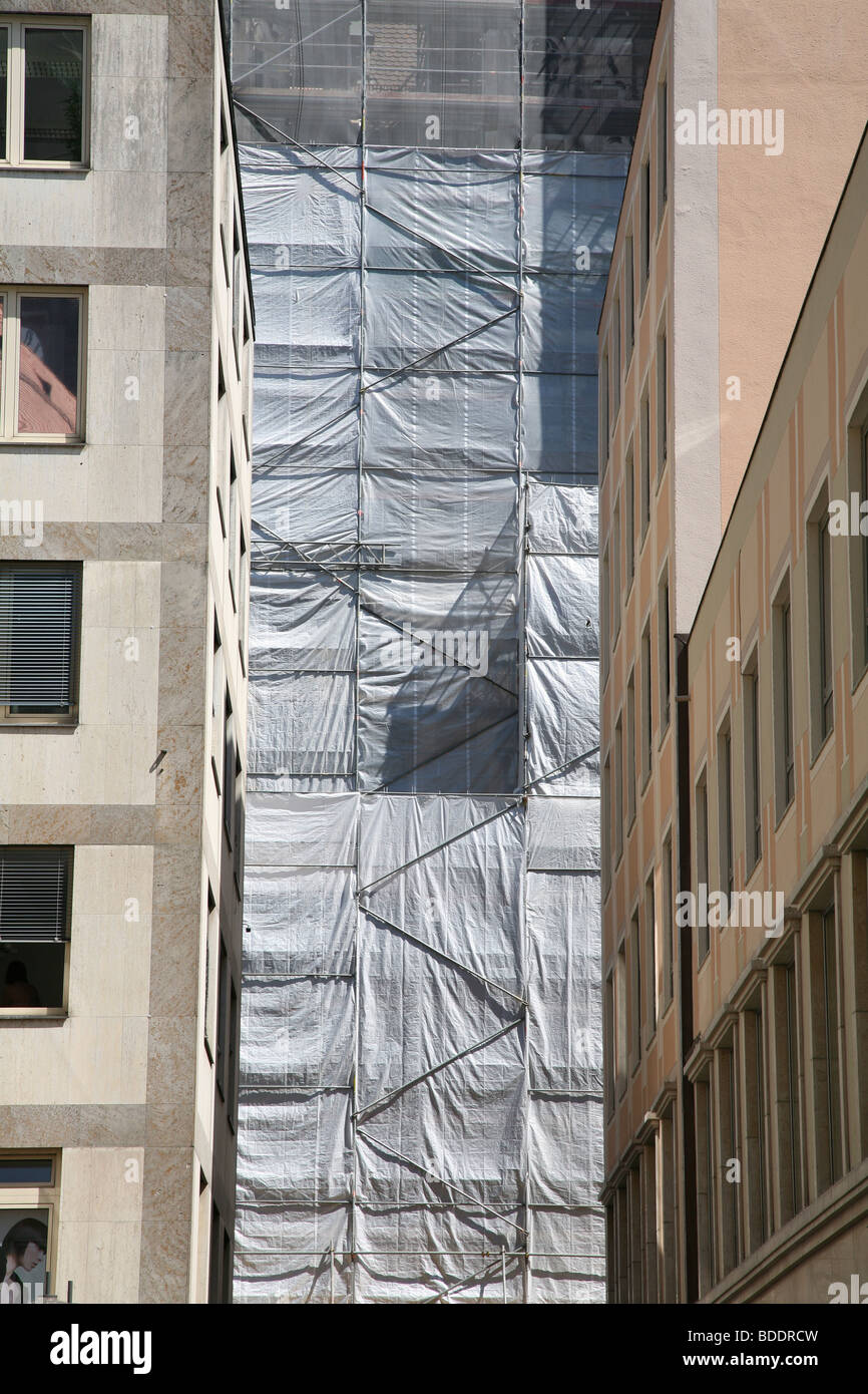 Plastic covered scaffolding on a building site in Munich, Germany Stock ...