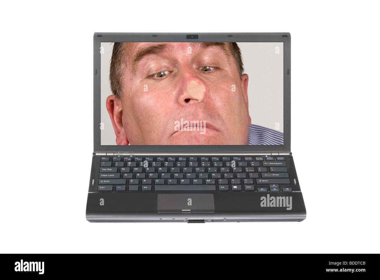 A man pressed his face against a laptop screen being nosy and ...
