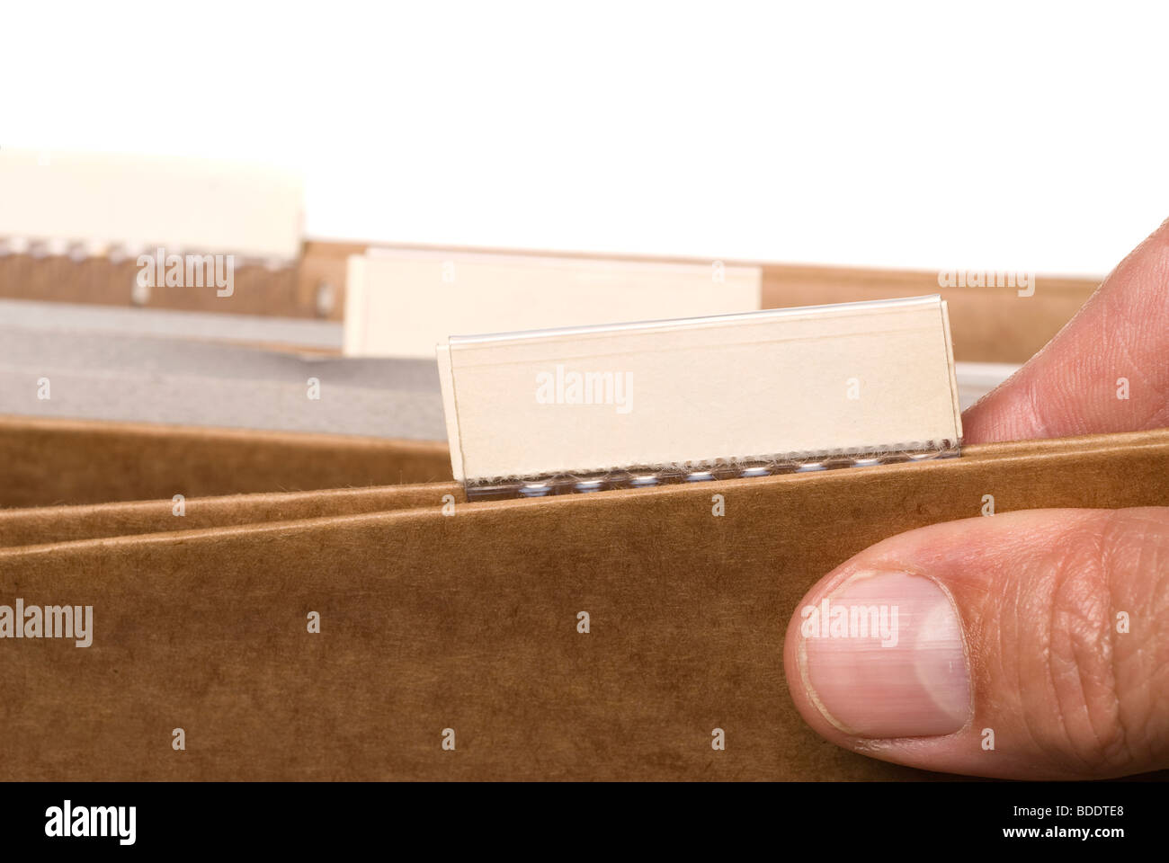 An office worker sorts through files. Copy space is left on the file ...