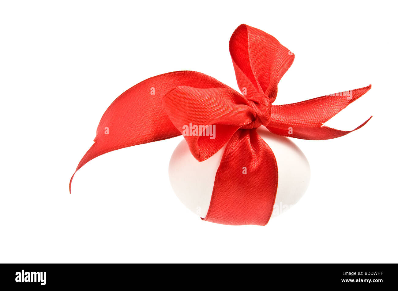 White egg wrapped around with red ribbon over white background Stock ...