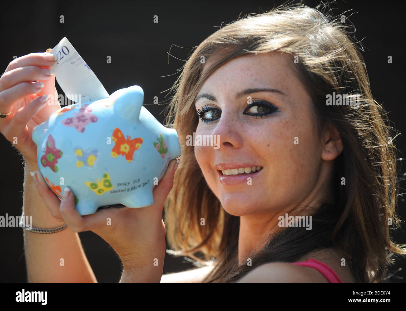 Woman and savings british pound hi-res stock photography and images - Alamy