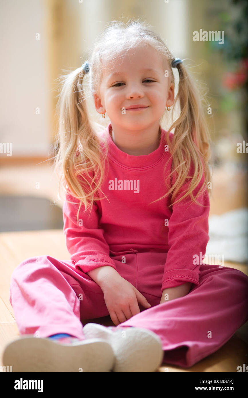 Portrait Of A Little Girl Sitting On The Floor Stock Photo Alamy