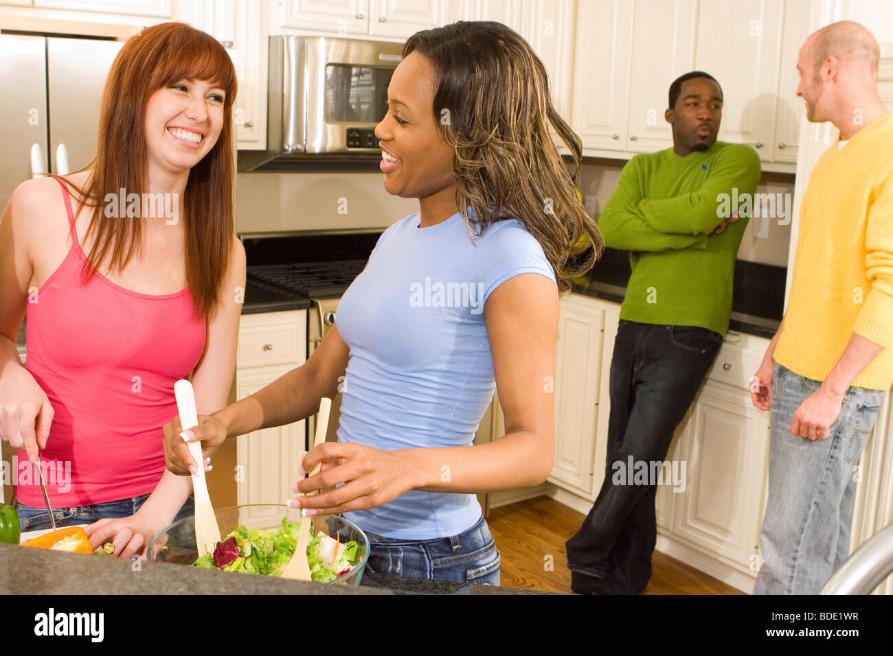 Friends get together in kitchen Stock Photo - Alamy