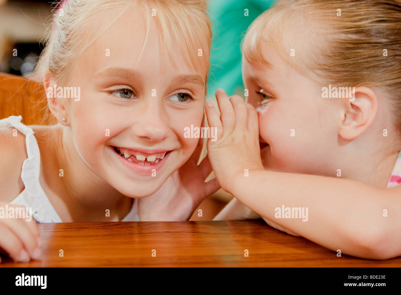 Children sharing a secret Stock Photo - Alamy