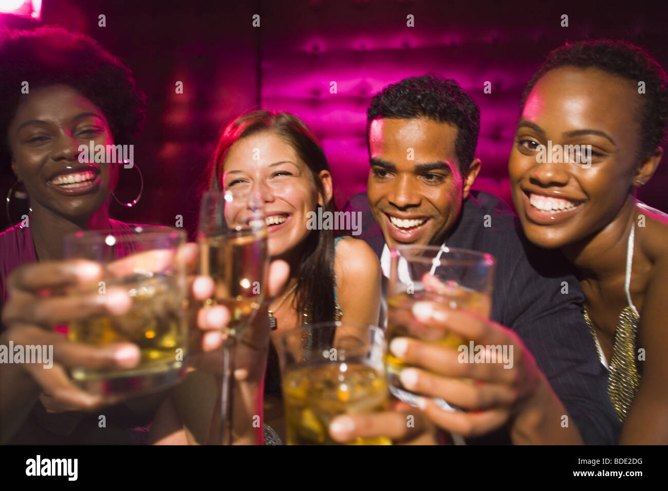 Young friends partying in night club setting Stock Photo - Alamy