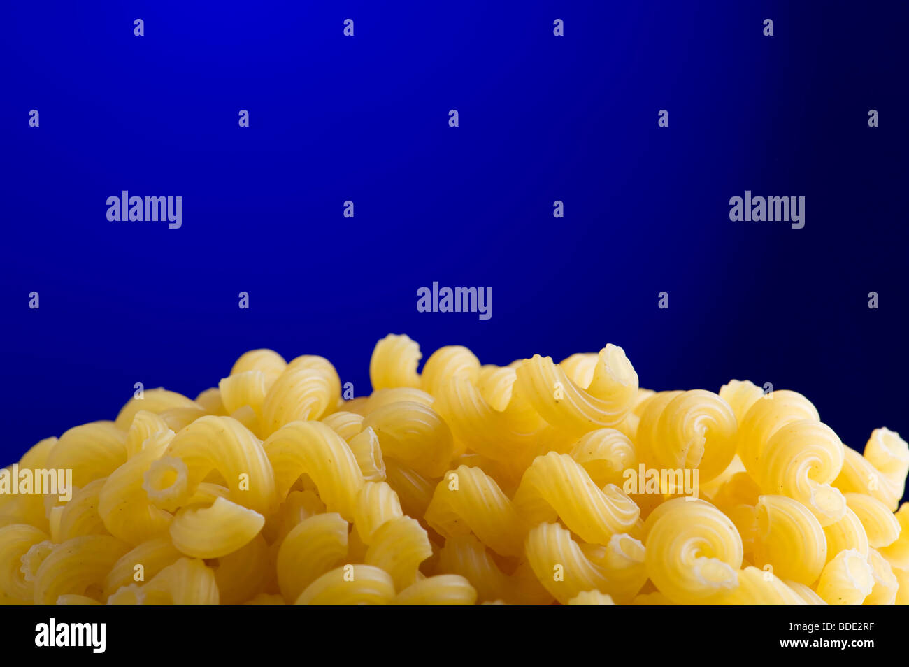 object on blue - macaroni close up Stock Photo - Alamy