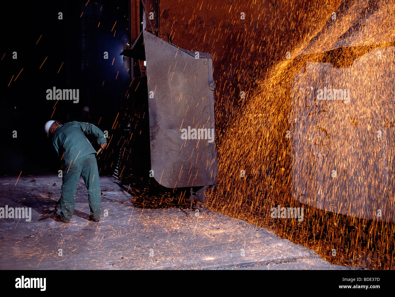 A worker is showered with sparks at the US Steel, Basic Oxygen Process ...