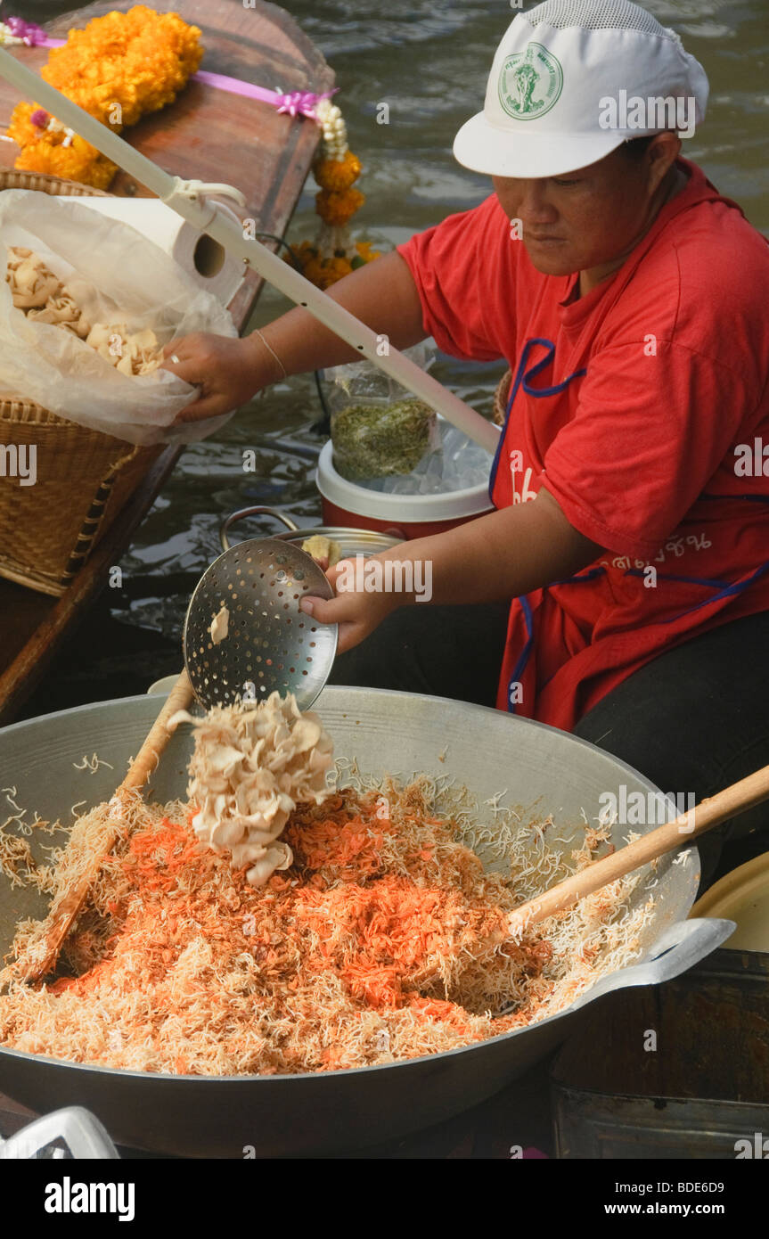 vendor making mee krop noodles at a floating market in Bangkok Thailand ...