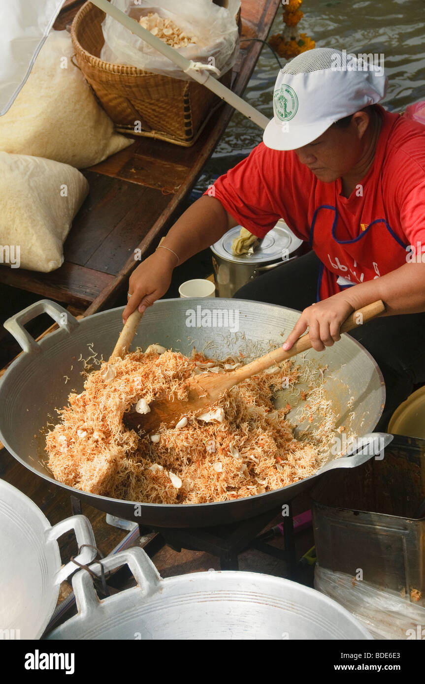 vendor making mee krob noodles at a floating market in Bangkok Thailand ...