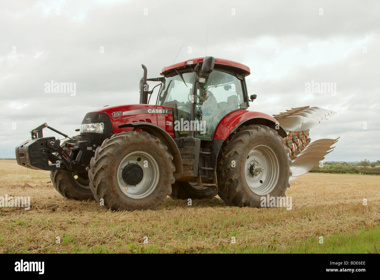 large tractor about to plough in stubble after harvest Stock Photo - Alamy