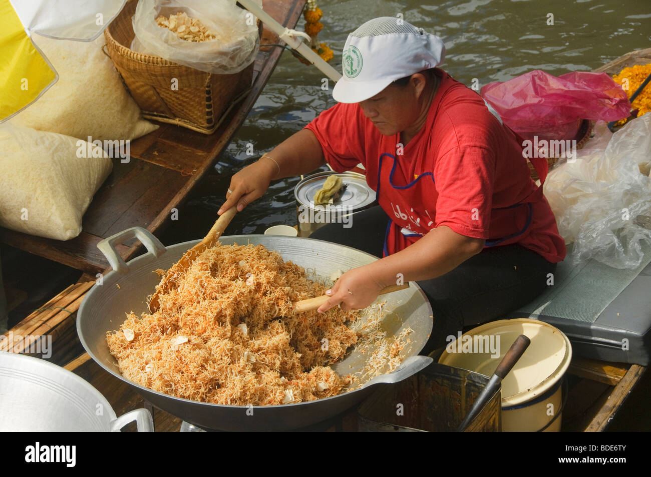 vendor making mee krop noodles at a floating market in Bangkok Thailand ...