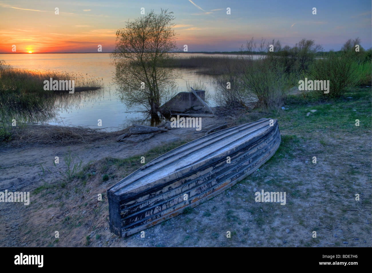 Lone boat ashore Lake Lubans Stock Photo - Alamy