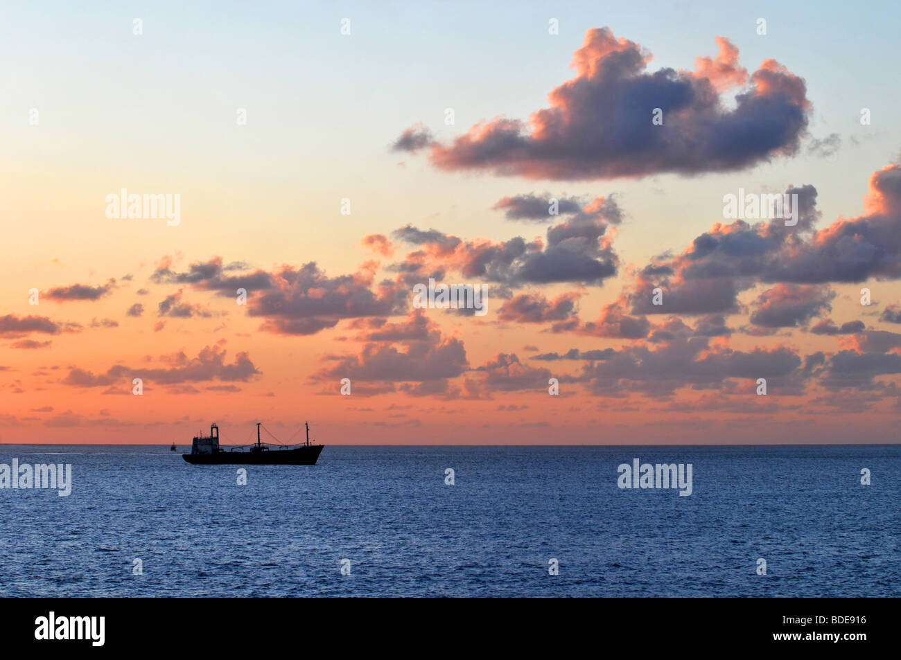 Colorful sunset at sea with merchant ships Stock Photo - Alamy