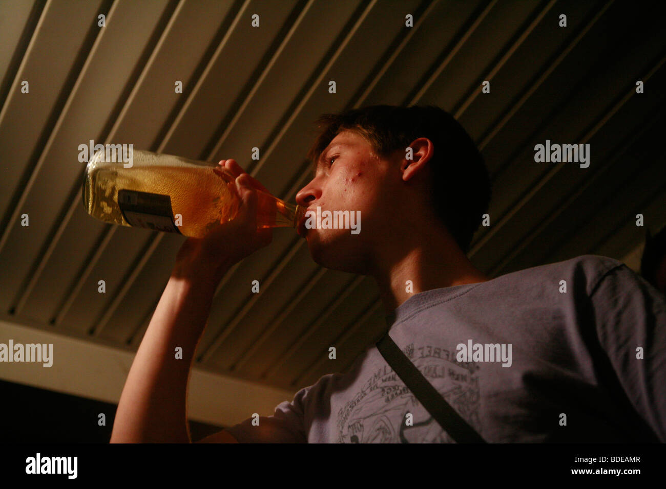 Justin Rhody drinks from a 40 ounce beer bottle during a punk show ...