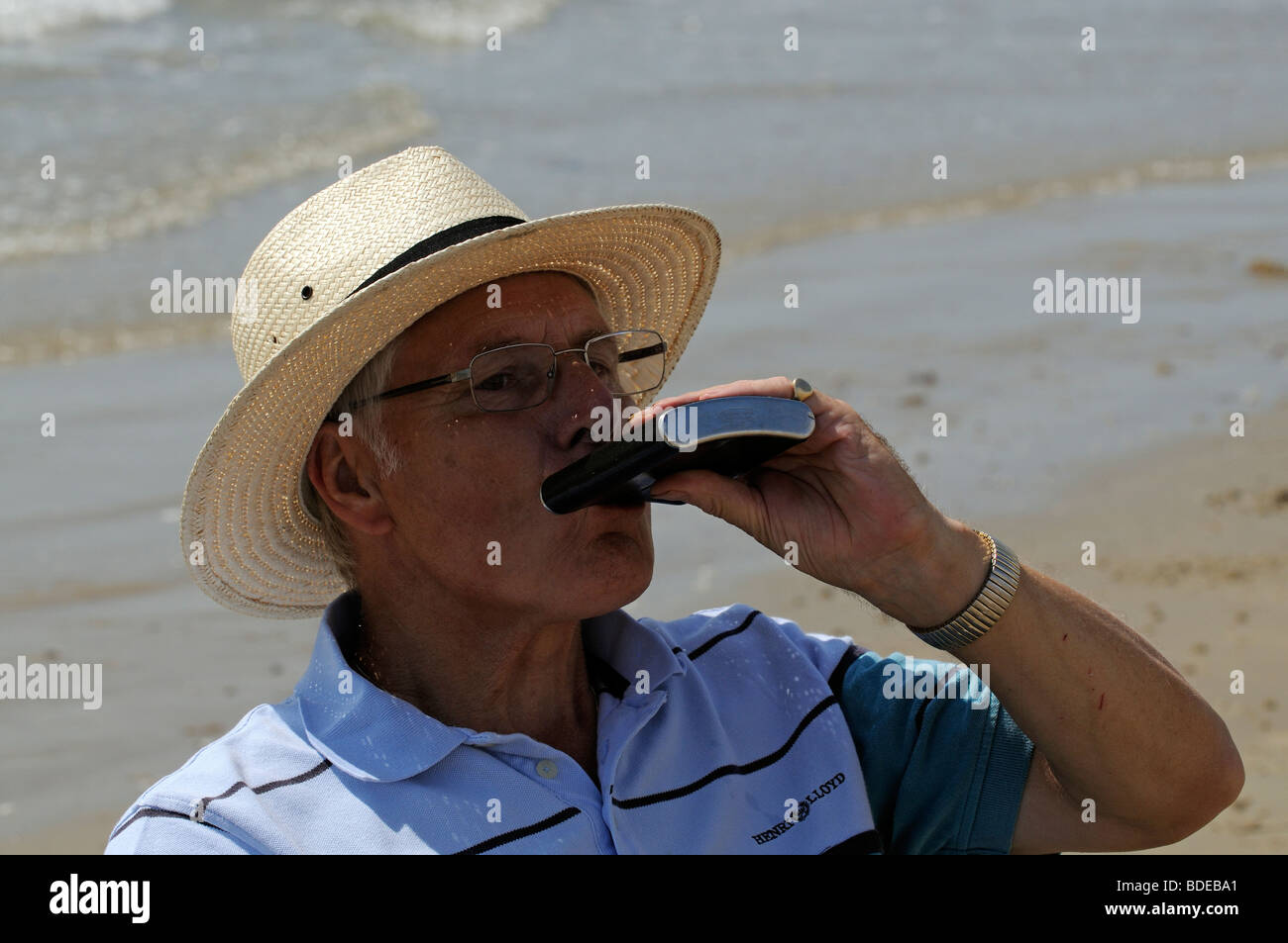Portrait of a man drinking from a hip flask Stock Photo - Alamy