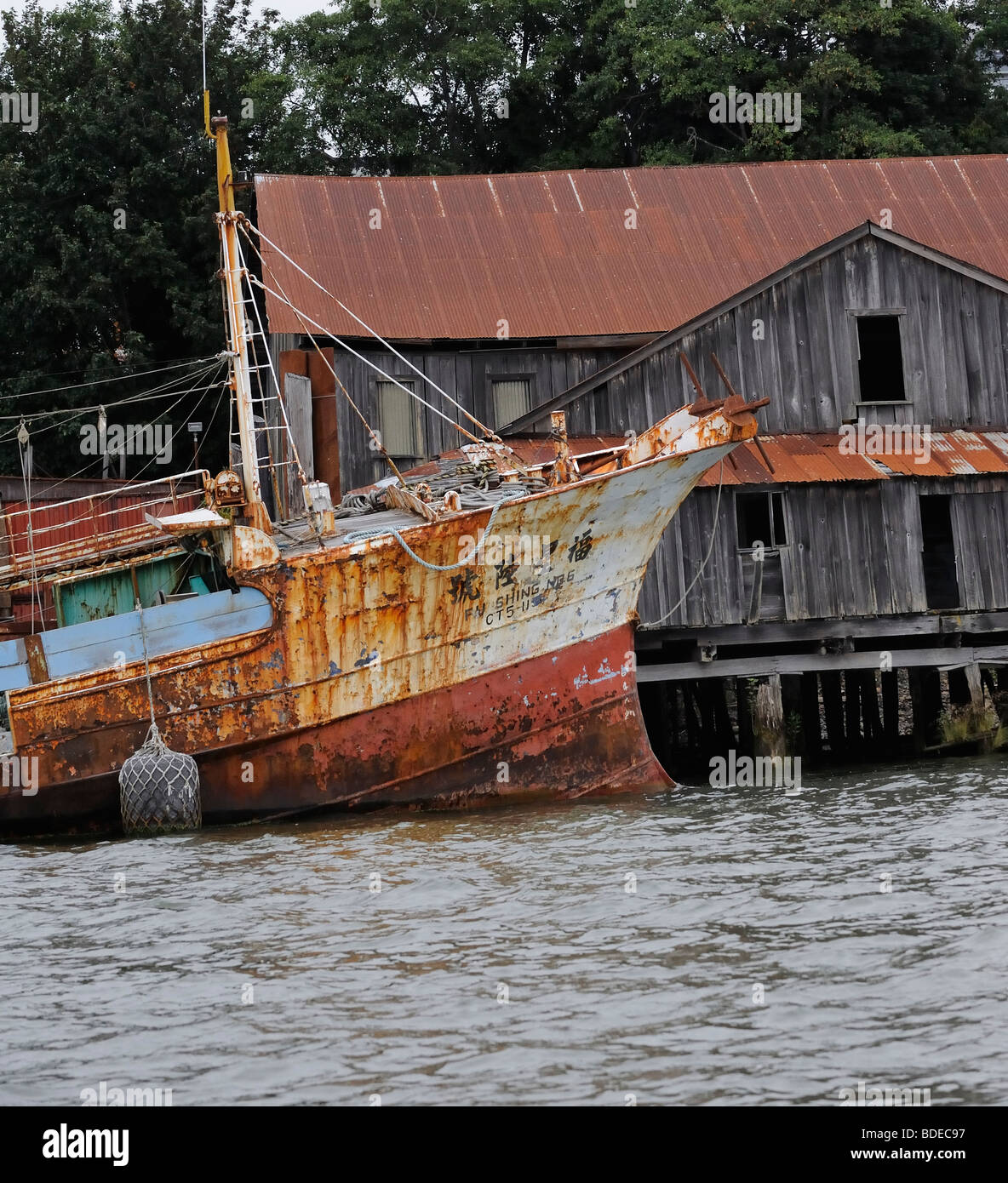 rusty old vessel at dock by weathered building derelict rusty Chinese ...