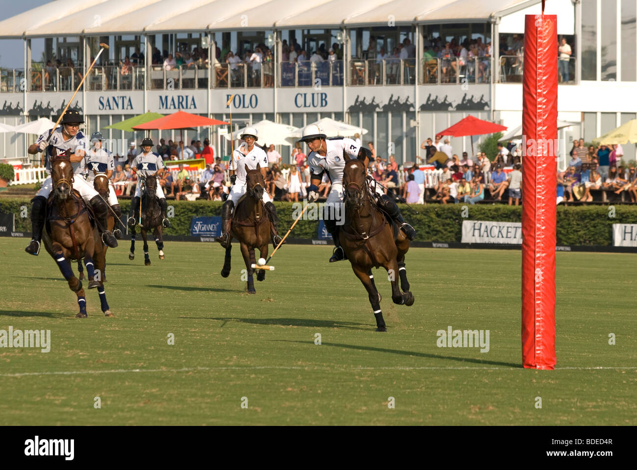 Polo player with ball on the end of stick heading for the goal, Santa ...